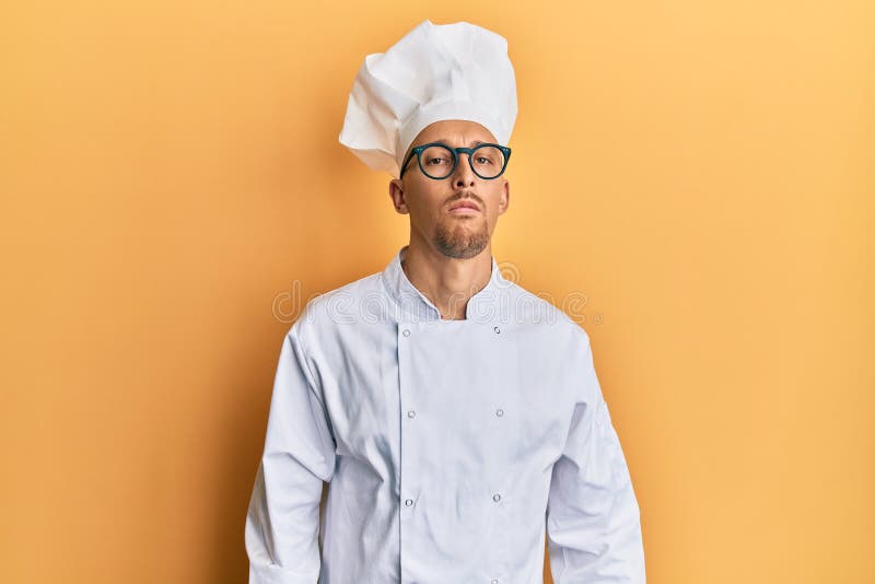 Bald Man with Beard Wearing Professional Cook Uniform Relaxed with ...