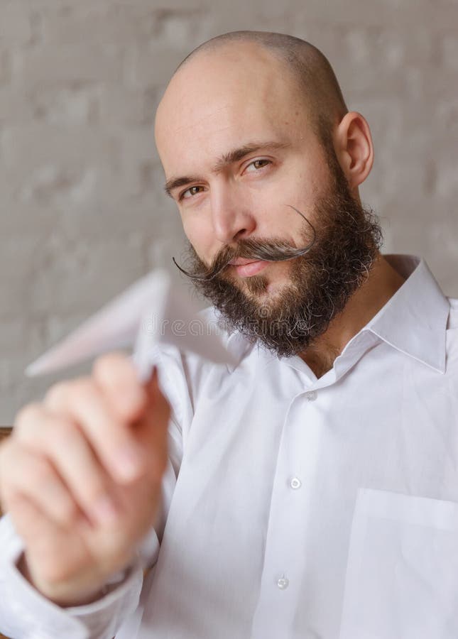 Bald Man with a Beard and a White Shirt Flying Paper Airplanes Stock ...