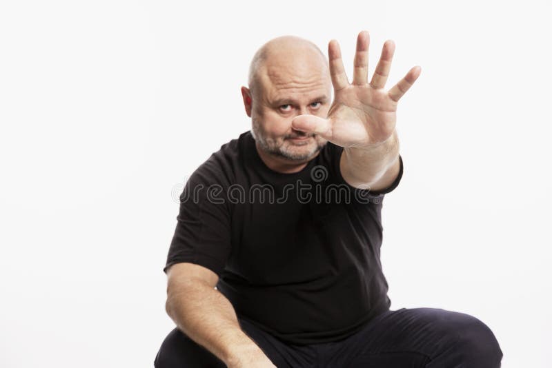 A Bald Man in a Black T-shirt Put His Palm Forward. White Background ...