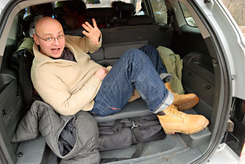 Bald man in car trunk stock image. Image of male, entering - 9450337