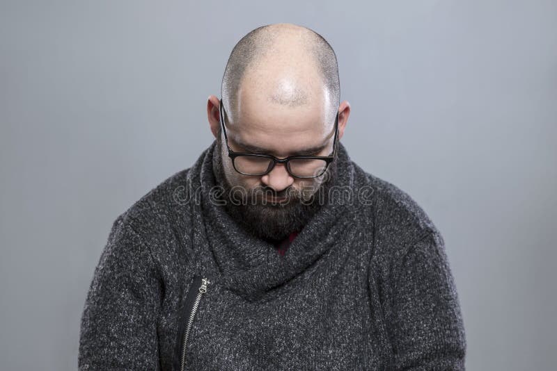 A Bald Man in Glasses with a Beard with His Head Down. Sadness ...