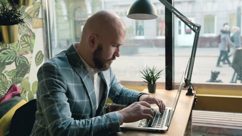 Bald Man in a Jacket Works on a Computer Stock Footage - Video of ...