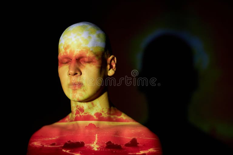 Bald Man Posing with Image of Nuclear Explosion Projecting on Face in ...