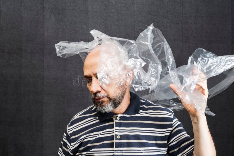 Bald Man Suffocating with a Transparent Plastic Bag Flying Over His ...