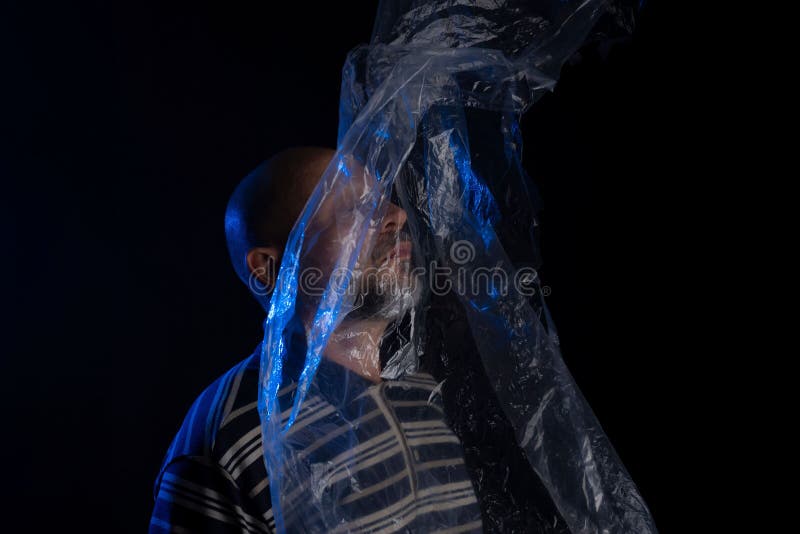 Bald Man Suffocating with a Transparent Plastic Bag Flying Over His ...