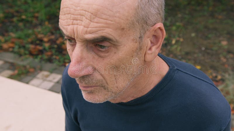 Bald Senior Man Sitting on Bench with Neutral Face Expression Stock ...