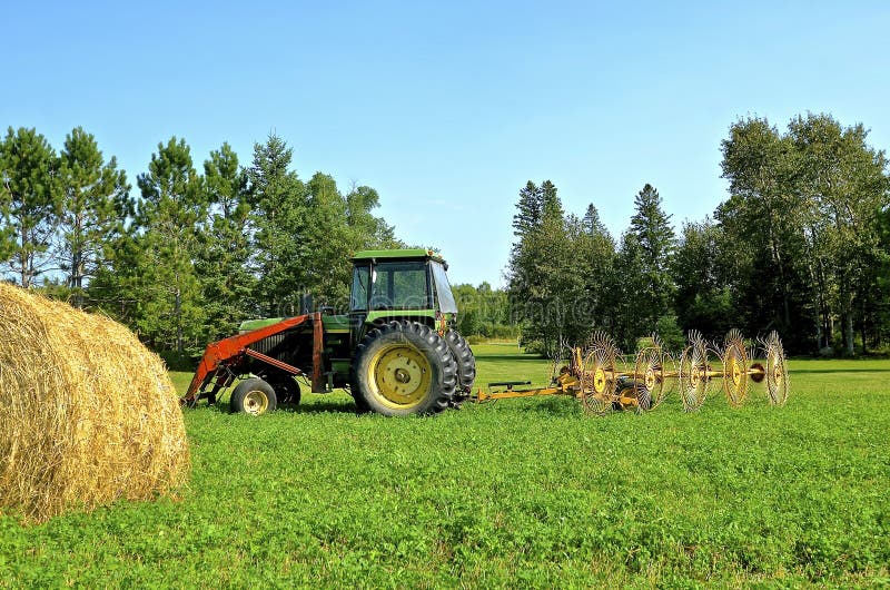 Bale, Tractor, and Wheel Rake Stock Image - Image of farming, wheels ...