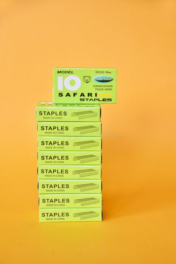 Staples in Green Box Isolated on Yellow Background Editorial ...