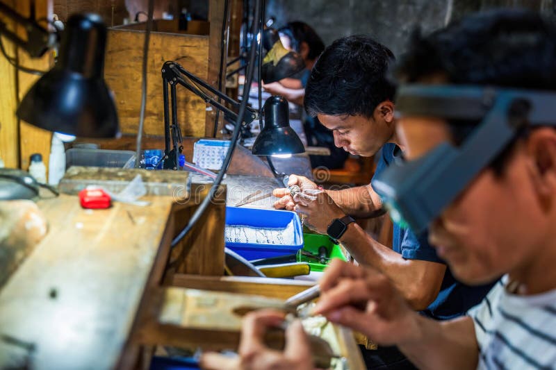 Skilled Craftsmen Focus Intently while Working on Detailed Designs in a ...