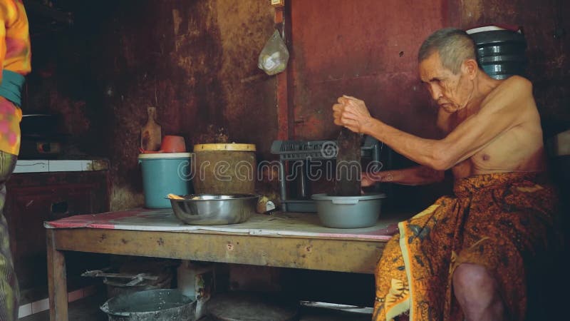 Balinese Old Man Grating Coconut in Village Kitchen Stock Footage ...