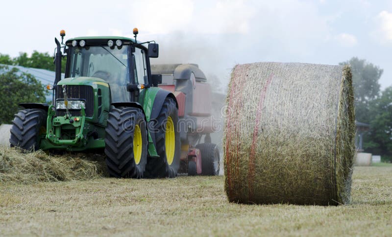 Baling hay in field stock image. Image of haying, bale - 1458963