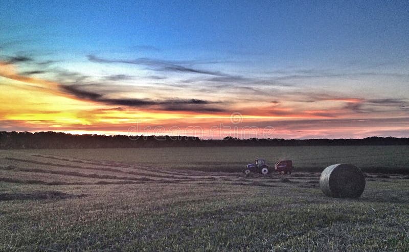 Baling Hay at Sunset stock photo. Image of baling, farm - 52514918