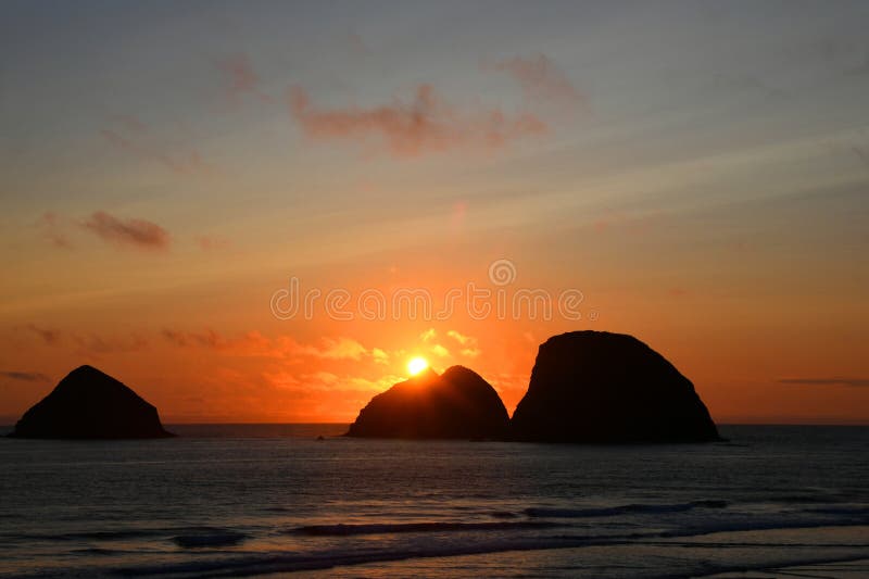 Ball of Fire Behind Sea Stacks Stock Photo - Image of setting, oregon ...