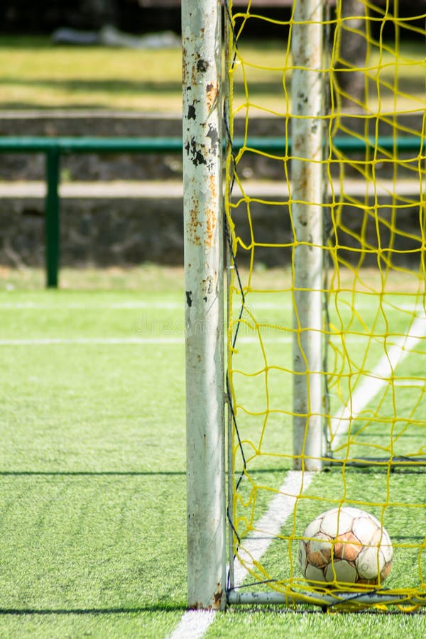 A Ball Inside the Goal of a 7-a-side Soccer Field Stock Photo - Image ...