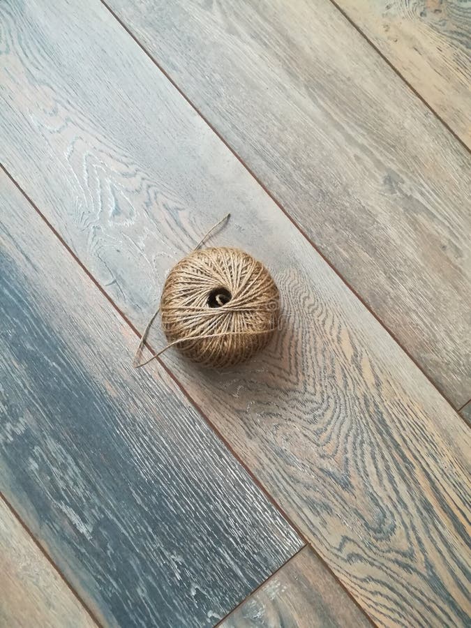 A Ball of Jute Thread on a Laminate Floor Stock Photo - Image of sand ...