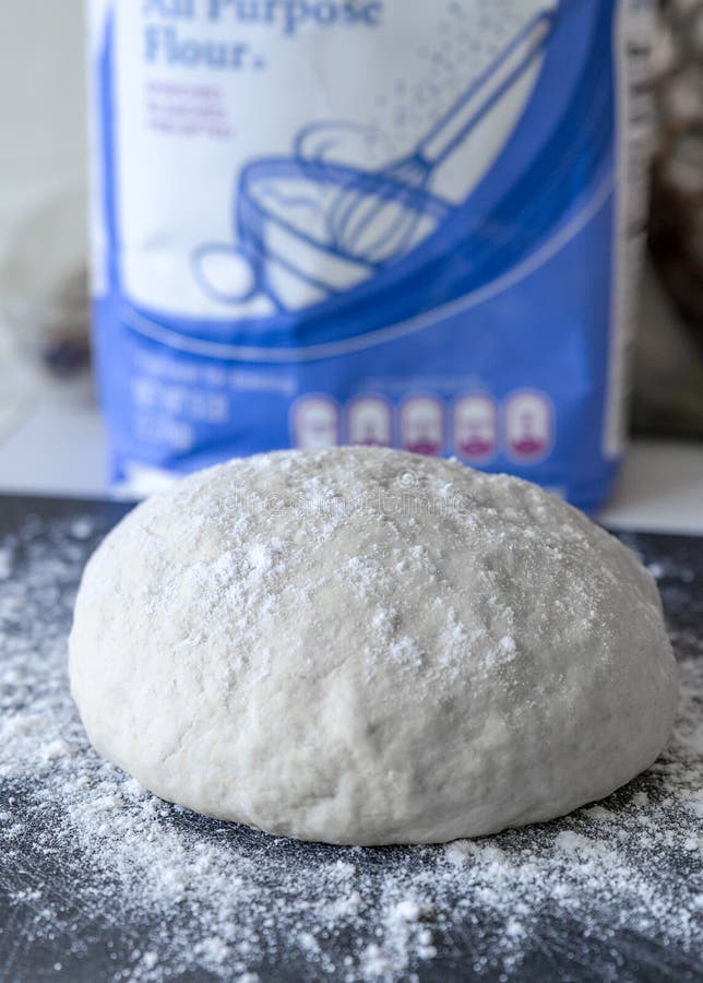 Ball of Rolled Flour Dough on Black Rolling Board Stock Photo - Image ...