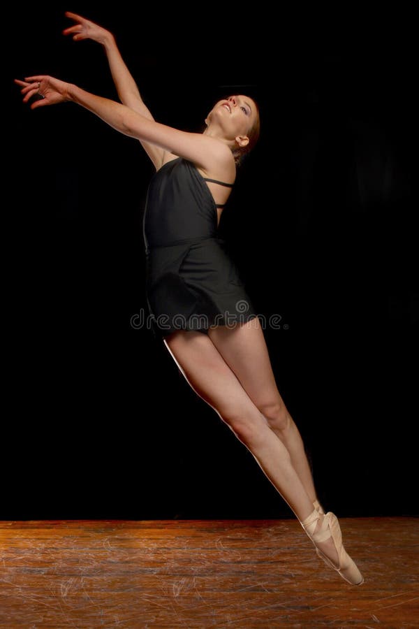 Ballerina Leaping in Studio on Black Background Stock Photo - Image of ...