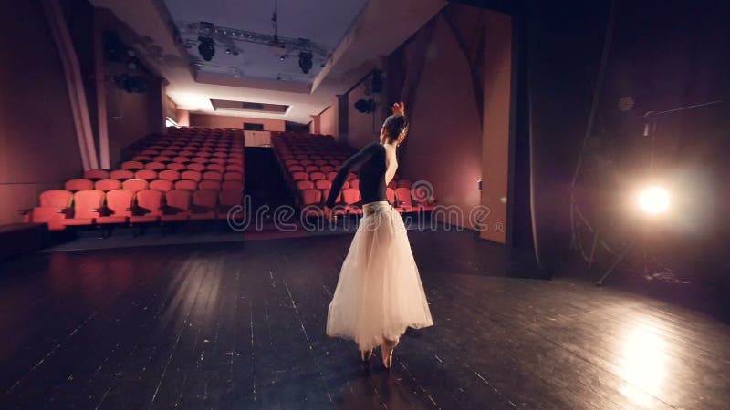 A Ballerina Turns Around in the Center of an Empty Stage. Stock Video ...
