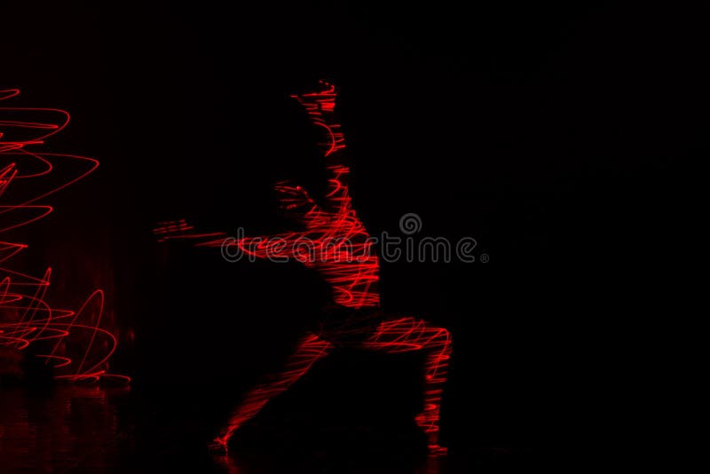 Ballet Dancer Dancing in Front of and Red Light while Expressing the ...