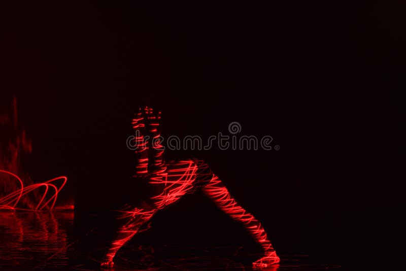 Ballet Dancer Dancing in Front of and Red Light while Expressing the ...