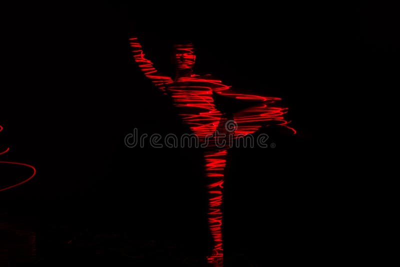 Ballet Dancer Dancing in Front of and Red Light while Expressing the ...