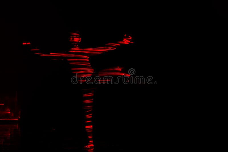 Ballet Dancer Dancing in Front of and Red Light while Expressing the ...