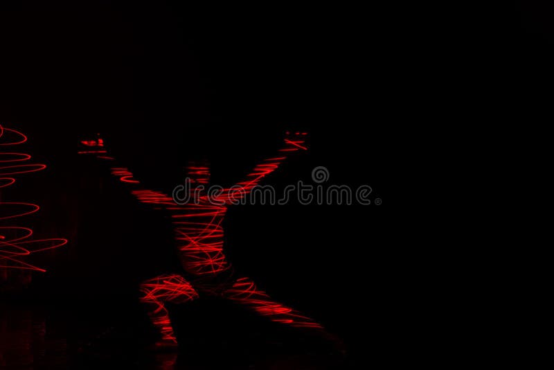 Ballet Dancer Dancing in Front of and Red Light while Expressing the ...