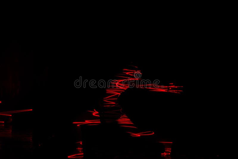 Ballet Dancer Dancing in Front of and Red Light while Expressing the ...