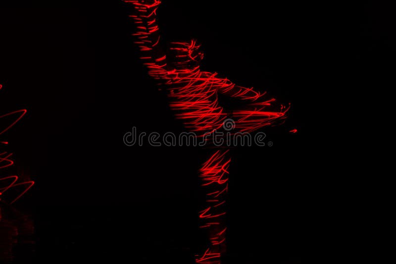 Ballet Dancer Dancing in Front of and Red Light while Expressing the ...