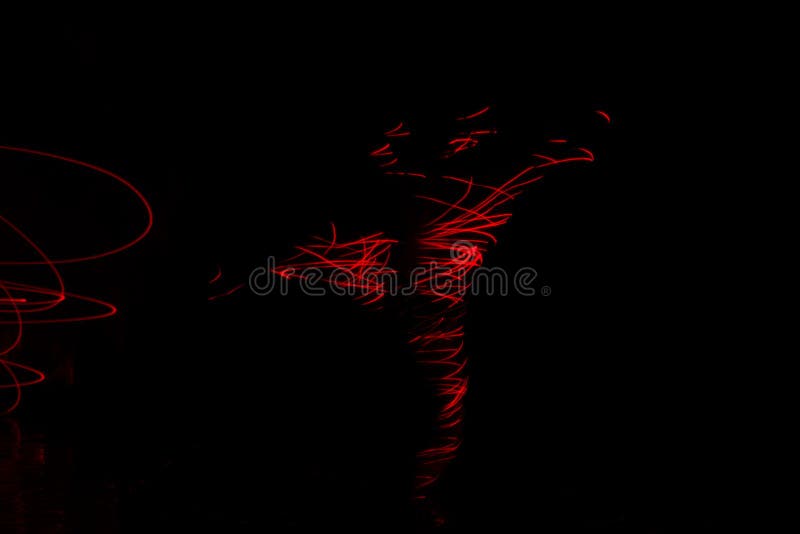 Ballet Dancer Dancing in Front of and Red Light while Expressing the ...