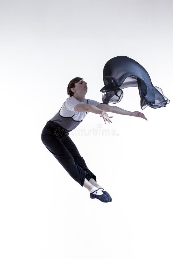 Ballet Dancer Performing in Flight with Hands Outspread in Studio Over ...