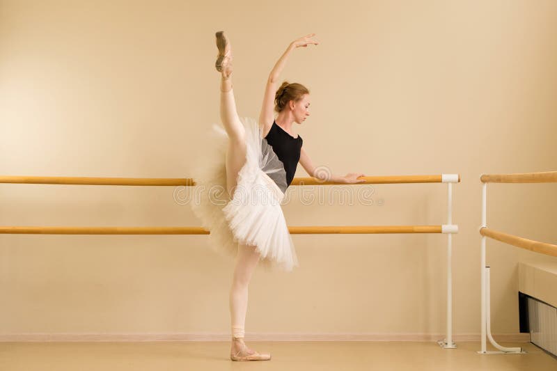 Ballet Dancer Performing High Leg Extension at Barre Stock Photo ...