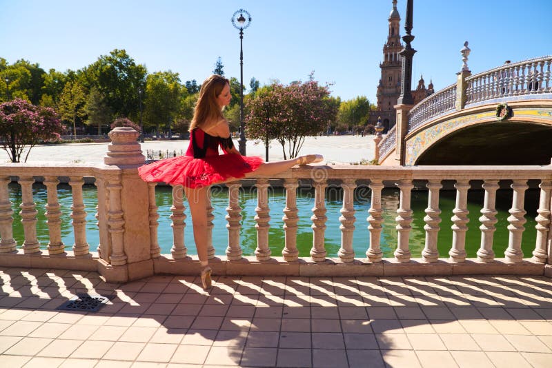 Ballet Dancer with Red Tutu Leaning on a Park Railing in Seville. the ...