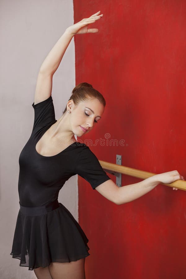 Ballet Dancer Stretching at Barre in Studio Stock Image - Image of ...