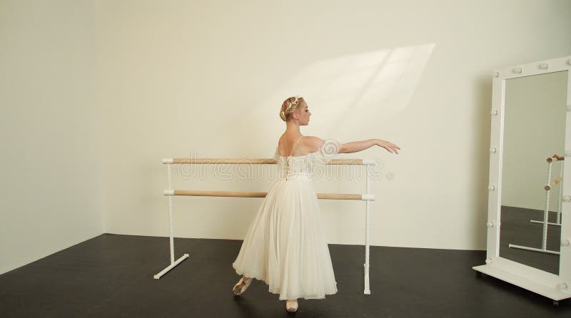 Ballet Dancer in White Dress Practicing at Barre in Sunlit Studio Stock ...