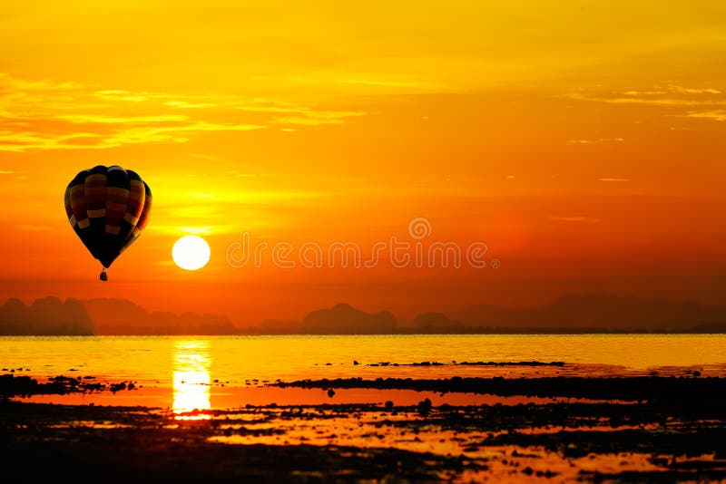 Balloon Flying into Sunset Over the Sea. Stock Image - Image of ...