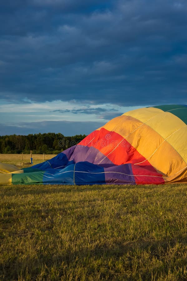 Hot Air Balloon Landed on the Field in the Village between Picturesque ...