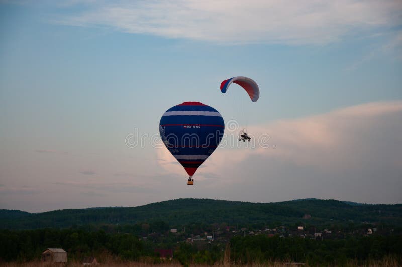 Balloon and Paraglider in the Evening Sky. Stock Photo - Image of ...