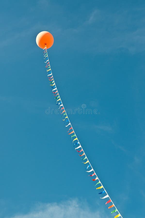 Balloon with Streamers in a Blue Sky Stock Image - Image of blowing ...
