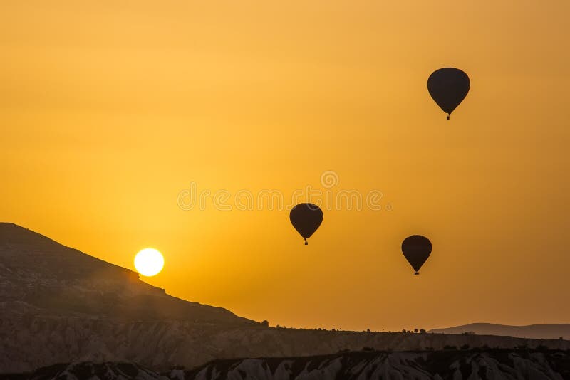 Balloons Fly Against the Sun during Sunrise Stock Image - Image of ...