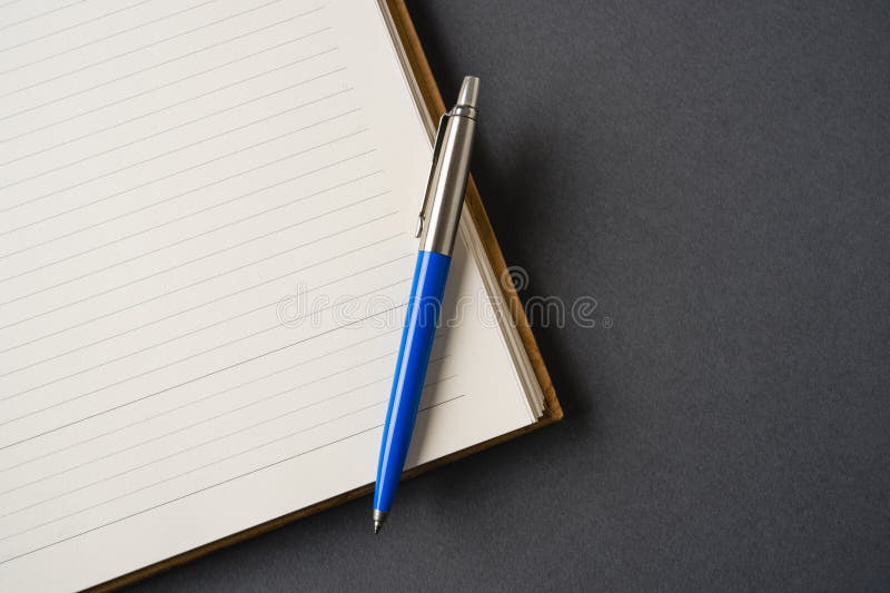 Ballpoint Pen Made of Blue Plastic and Metal Standing on Lined Notebook ...