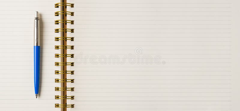 Ballpoint Pen Made of Blue Plastic and Metal Standing on Lined Notebook ...