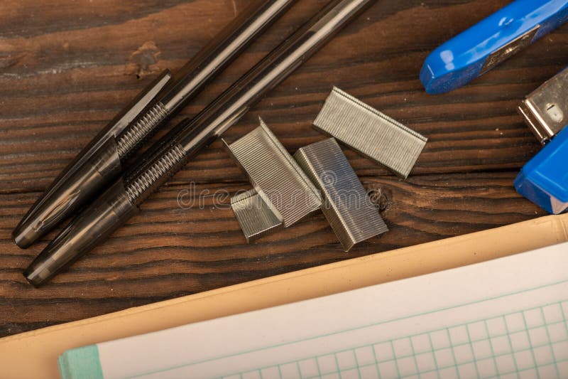 Ballpoint Pen, Stapler, and Stapler Staples a Checkered Notebook Sheet ...