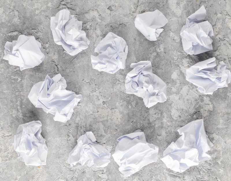 Balls of Crumpled Paper on a Gray Concrete Surface. Stock Image - Image ...