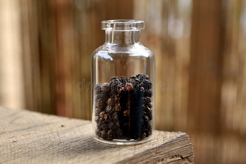 Balls of Whole Black Pepper in a Small Glass Bottle Stock Photo - Image ...