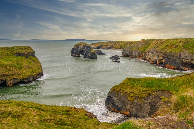 A Stone Beach with Cliffs in Background, Ireland. Stock Image - Image ...