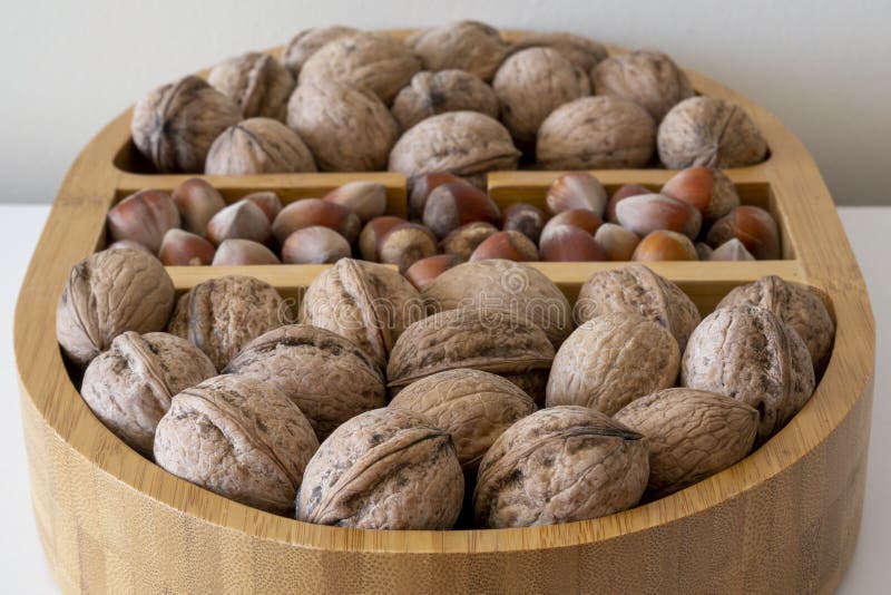 Bamboo bowl with walnuts stock photo. Image of black - 182894990