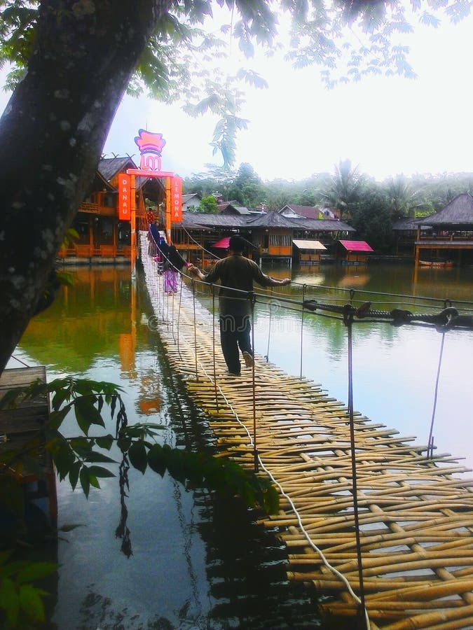Bamboo Bridge through the Lake Editorial Photography - Image of water ...