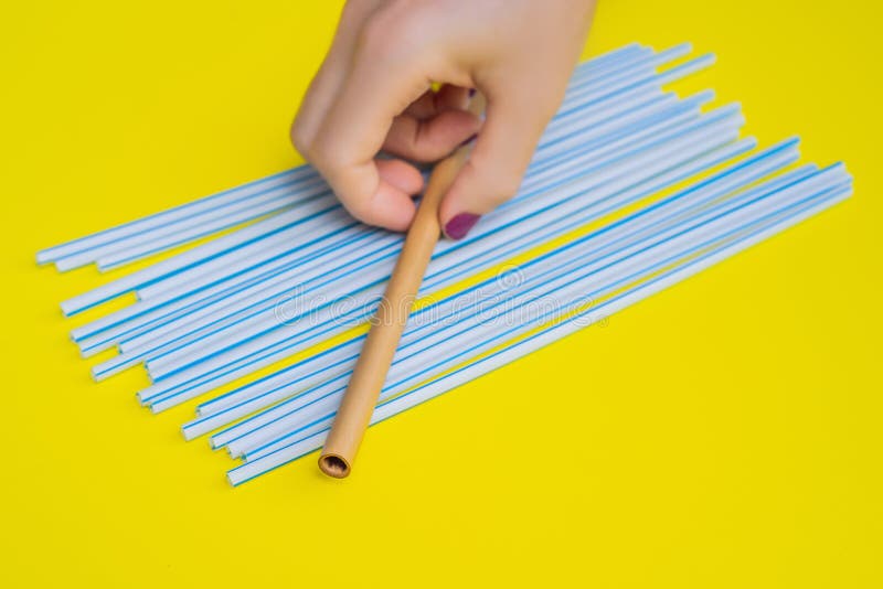 Bamboo Drinking Straw Vs Disposable Straws on a Yellow Background. Zero ...
