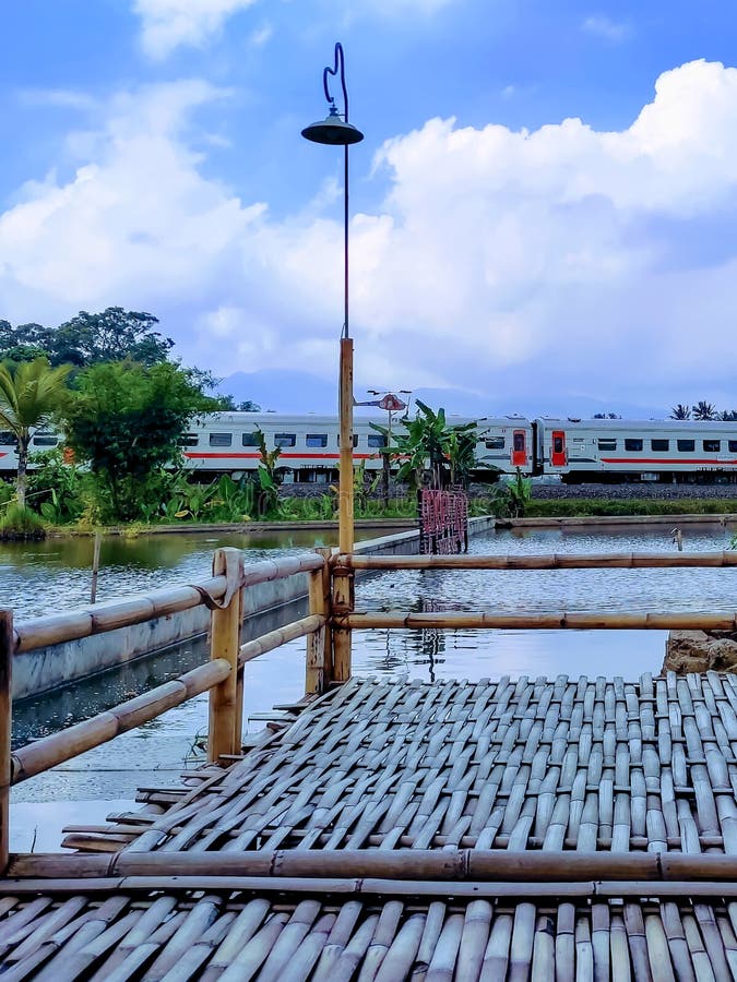 Bamboo Lamp Post and Train Under Blue Sky with Rustic Bamboo Fence and ...